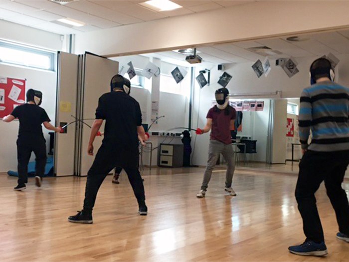 Champion helps students to master fencing
